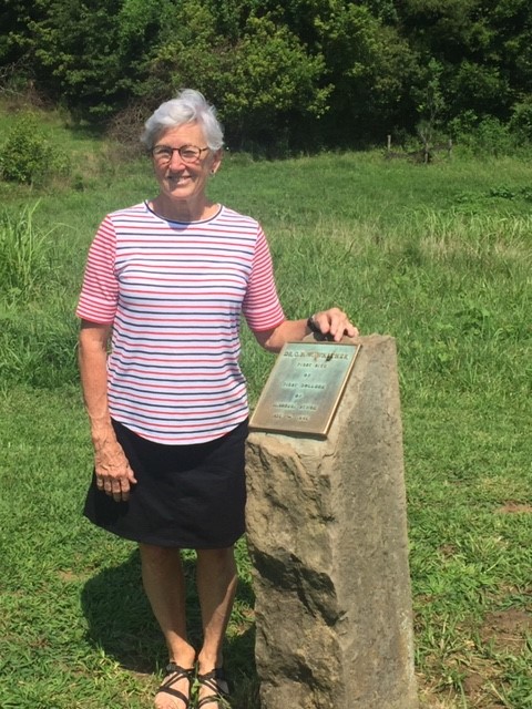 Pam Scheible at monument and Buenger Well